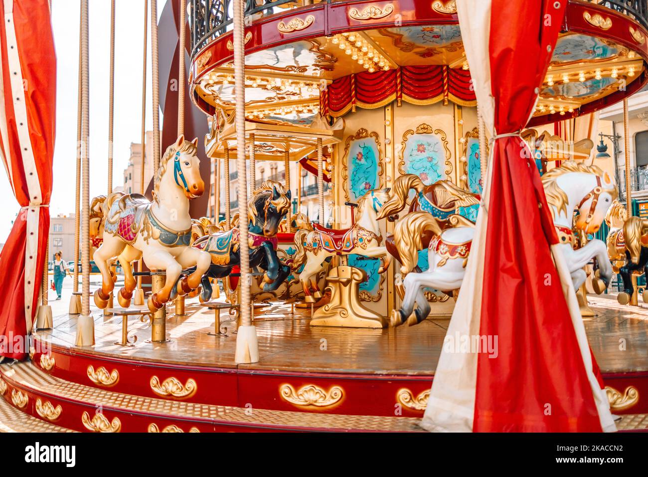 Old carousel in the park. Three horses and a plane on a traditional ...