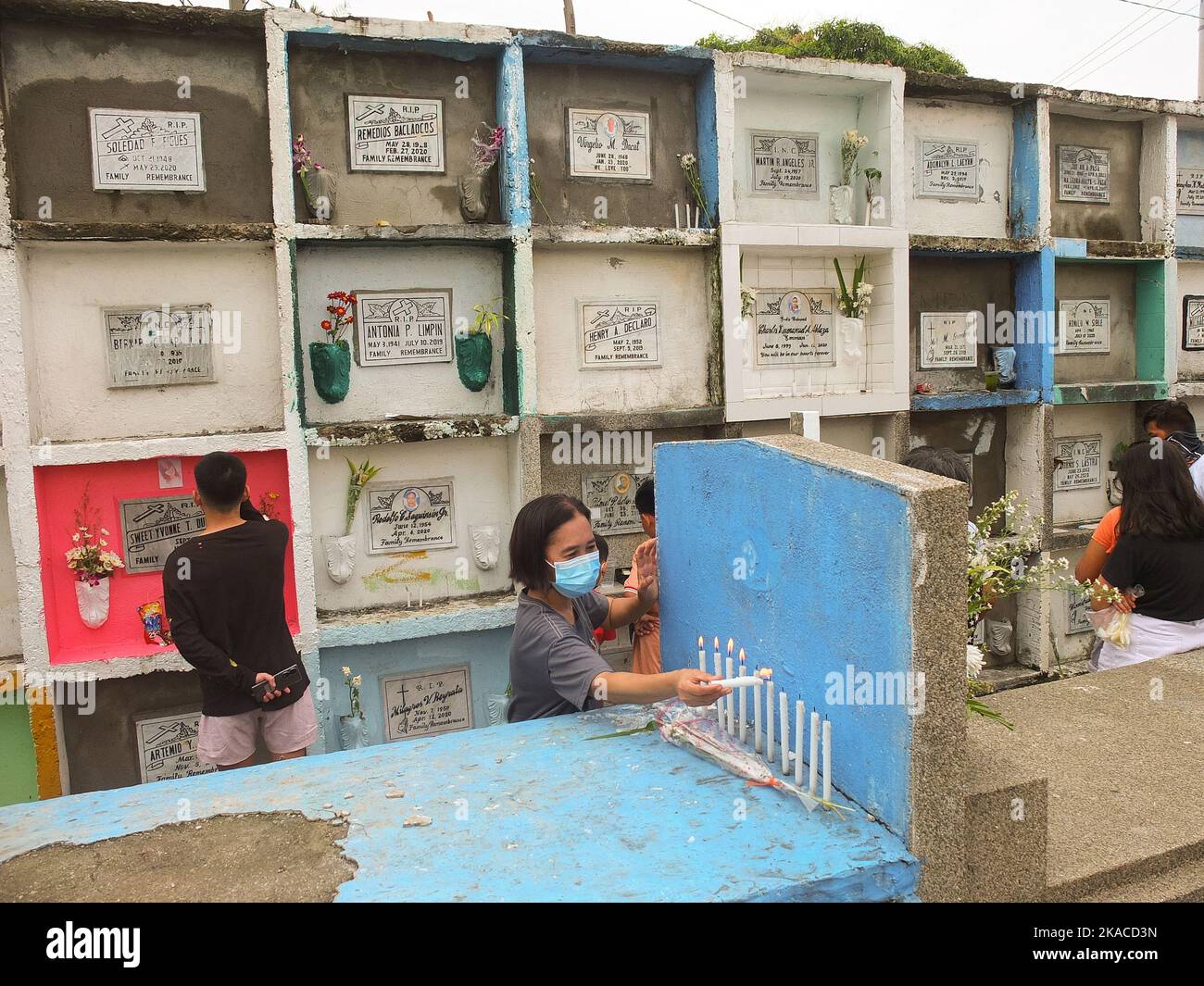 Caloocan City, Philippines. 01st Nov, 2022. A woman light candles at ...