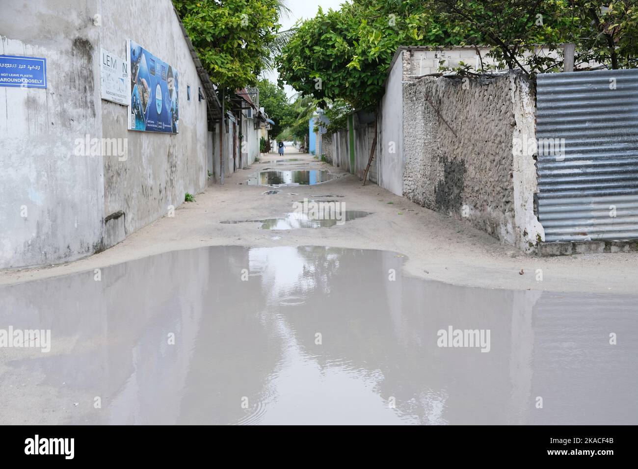 The monsoon season of Rasdhoo, with rainwater around the street ...