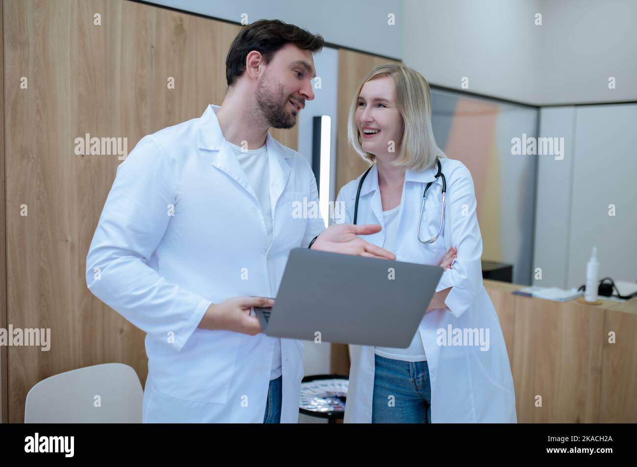 Clinic doctors communicating in the reception area Stock Photo - Alamy