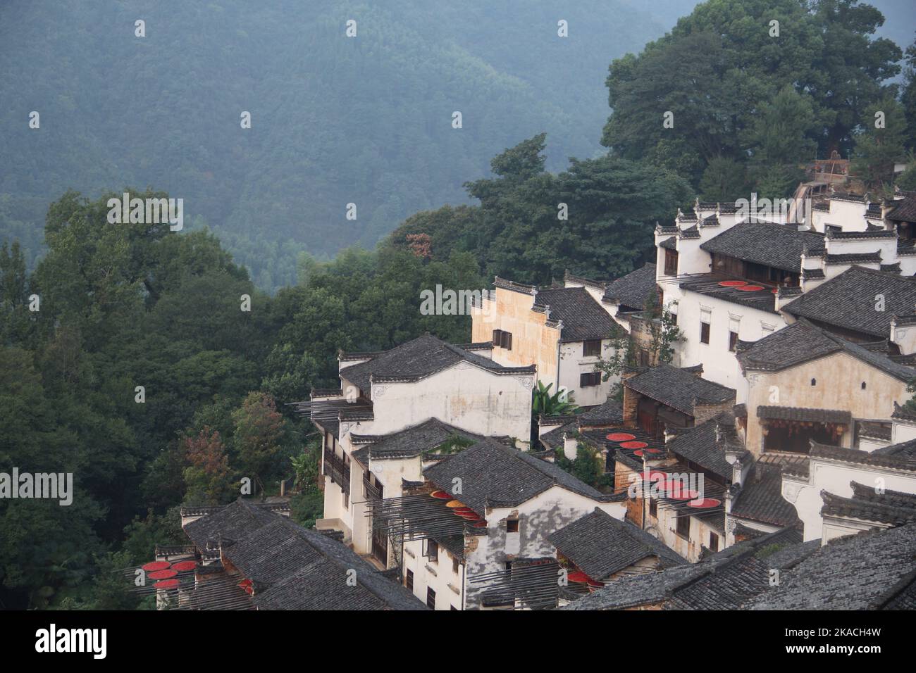 People drying crops in front of their houses in ancient Wuyuan villages ...