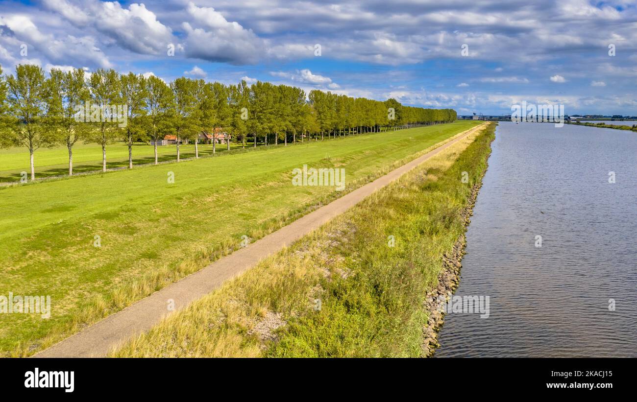 Aerial view of cycling track along Dike and canal near Ens in Flevoland ...