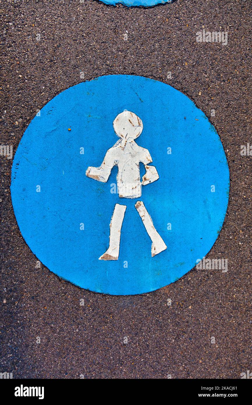 symbol for pathway and icon for pedestrians on asphalt Stock Photo - Alamy