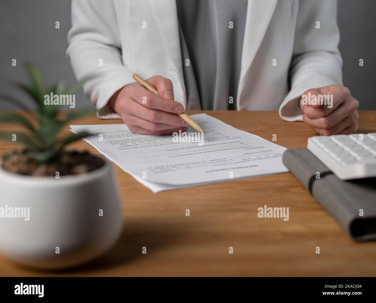 Female hand signing legal business contract with pen. Signature by ...