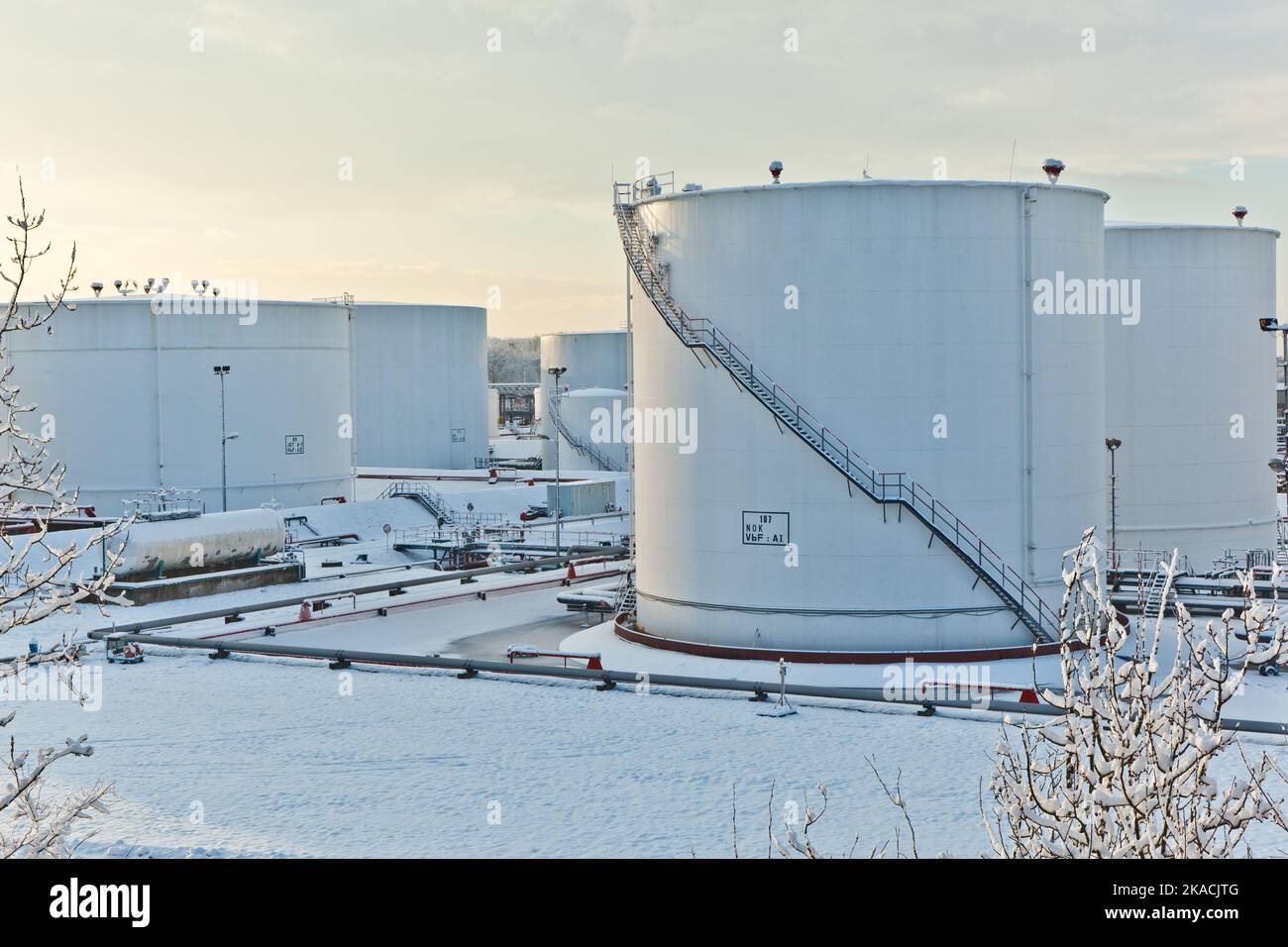 white tanks in tank farm with iron staircase in snow Stock Photo - Alamy