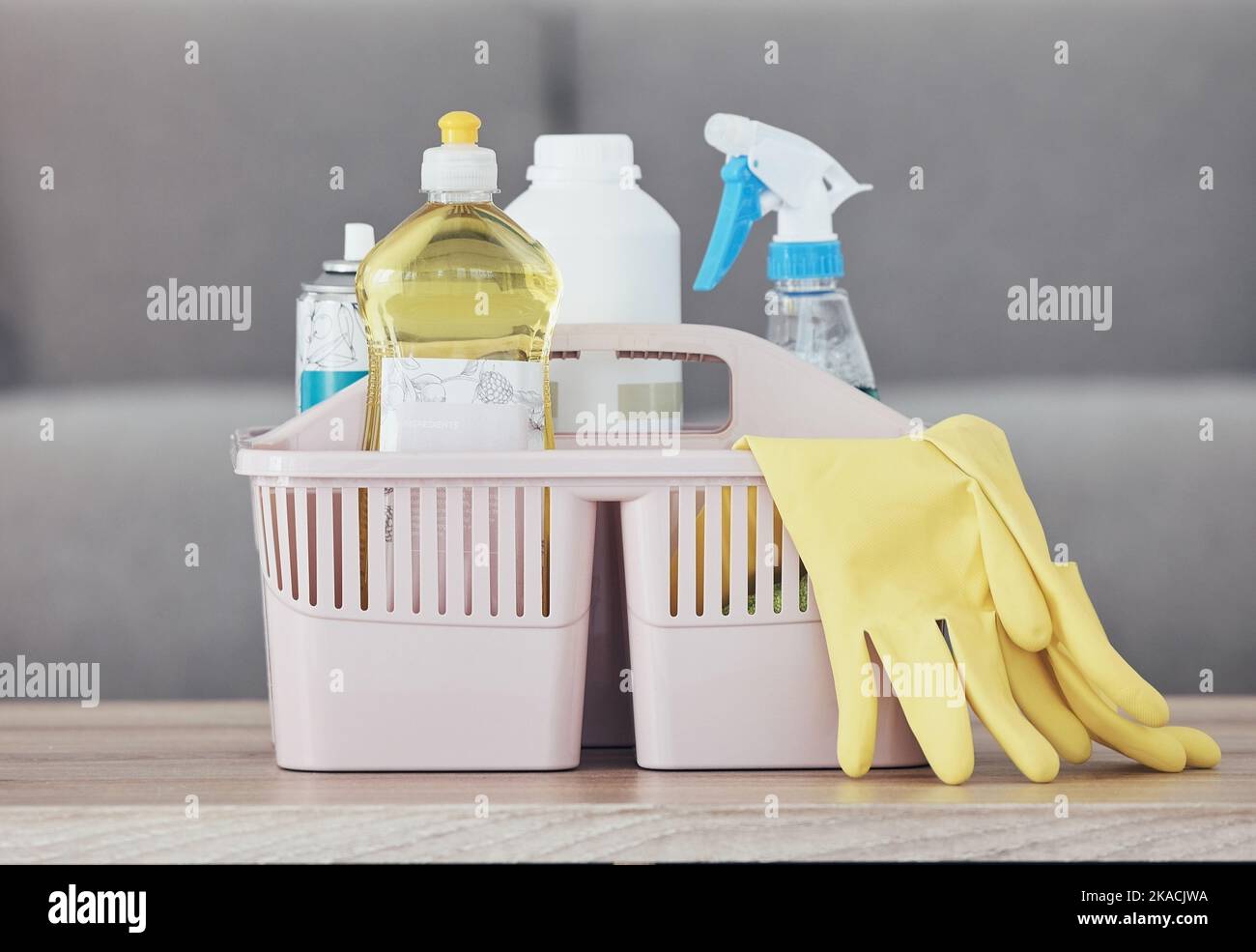 Cleaning container, spray bottle or rubber gloves on table in house ...