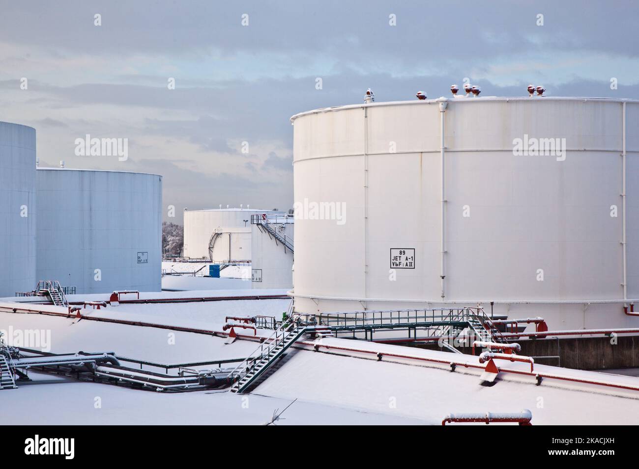 white tanks in tank farm with iron staircase in snow Stock Photo - Alamy