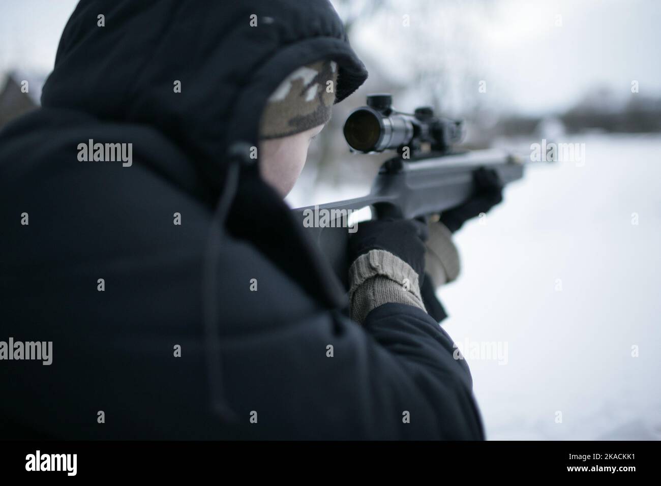 A beautiful woman holding rifle and take aim. Ready to shoot, target ...