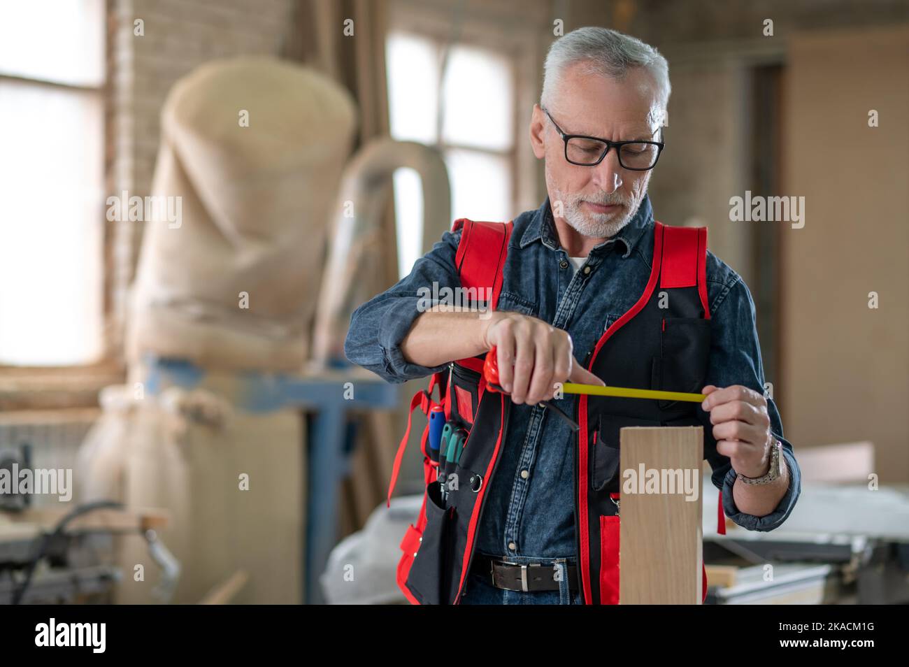 Carpenter making measurements with a measuring tape Stock Photo - Alamy