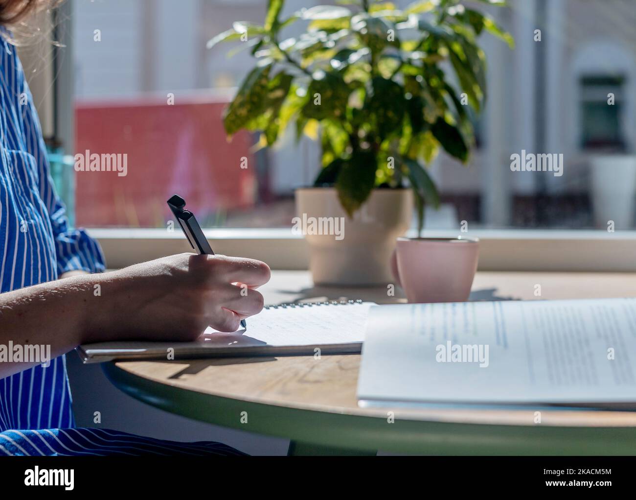 Student hands close up writing with pen in notepad, taking notes ...