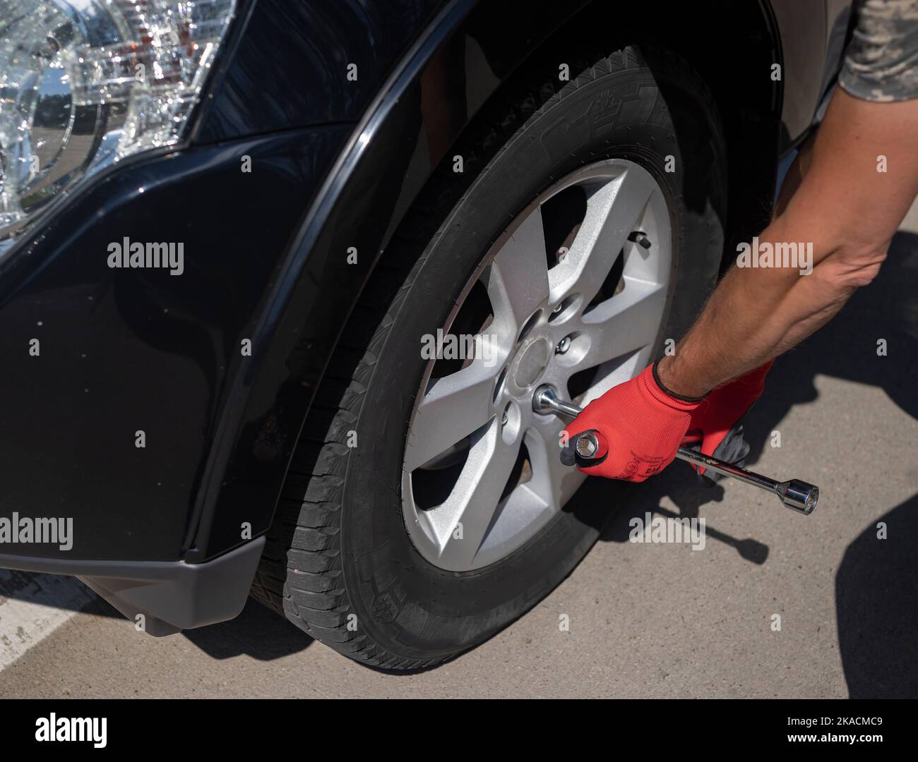 Fixing and checking wheel of car with metal tool, close up Stock Photo ...