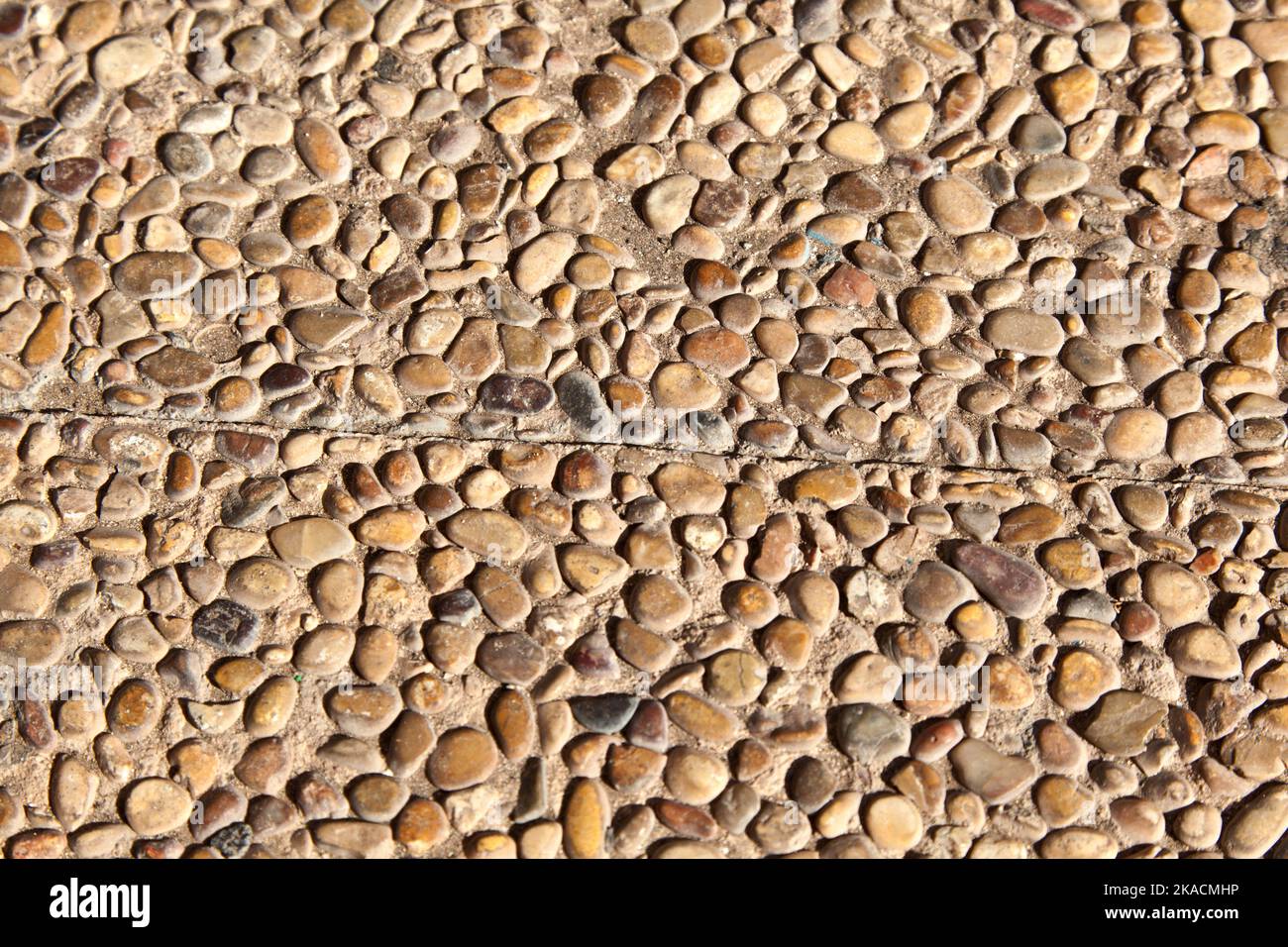 pattern of stones in concrete Stock Photo - Alamy