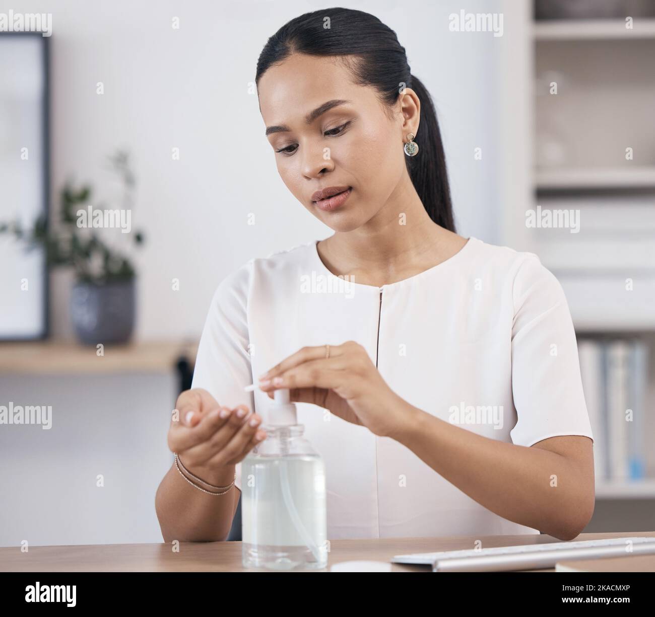 Business woman, hand sanitizer and covid risk management in office for ...