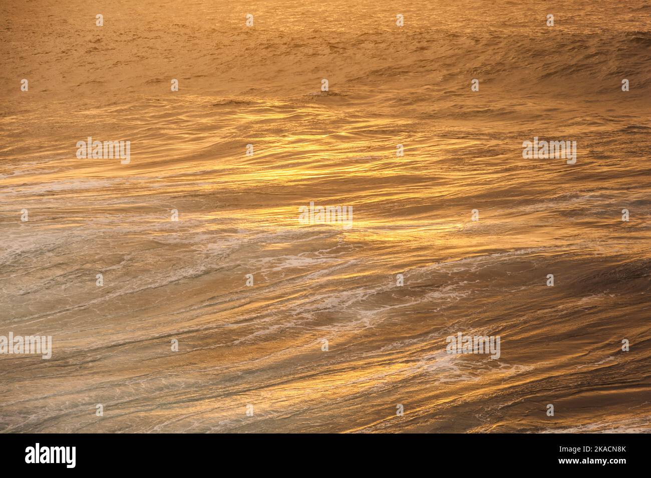 beautiful waves at the beach in sunset Stock Photo - Alamy
