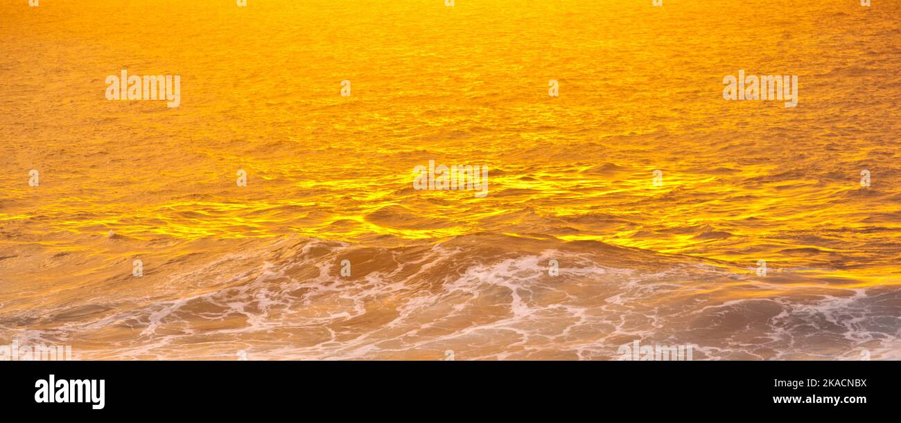 beautiful waves at the beach in sunset Stock Photo - Alamy