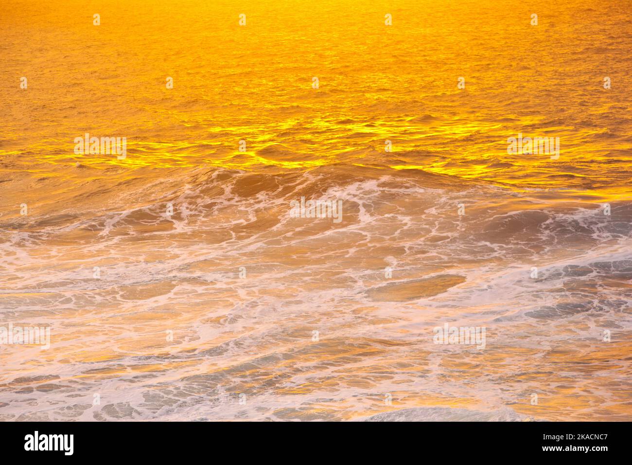 beautiful waves at the beach in sunset Stock Photo - Alamy