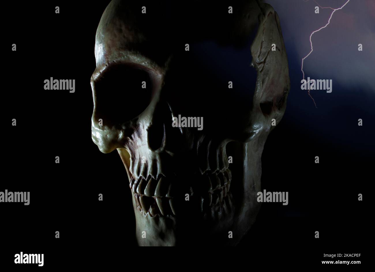 Skull on a dark background with lightning behind Stock Photo - Alamy