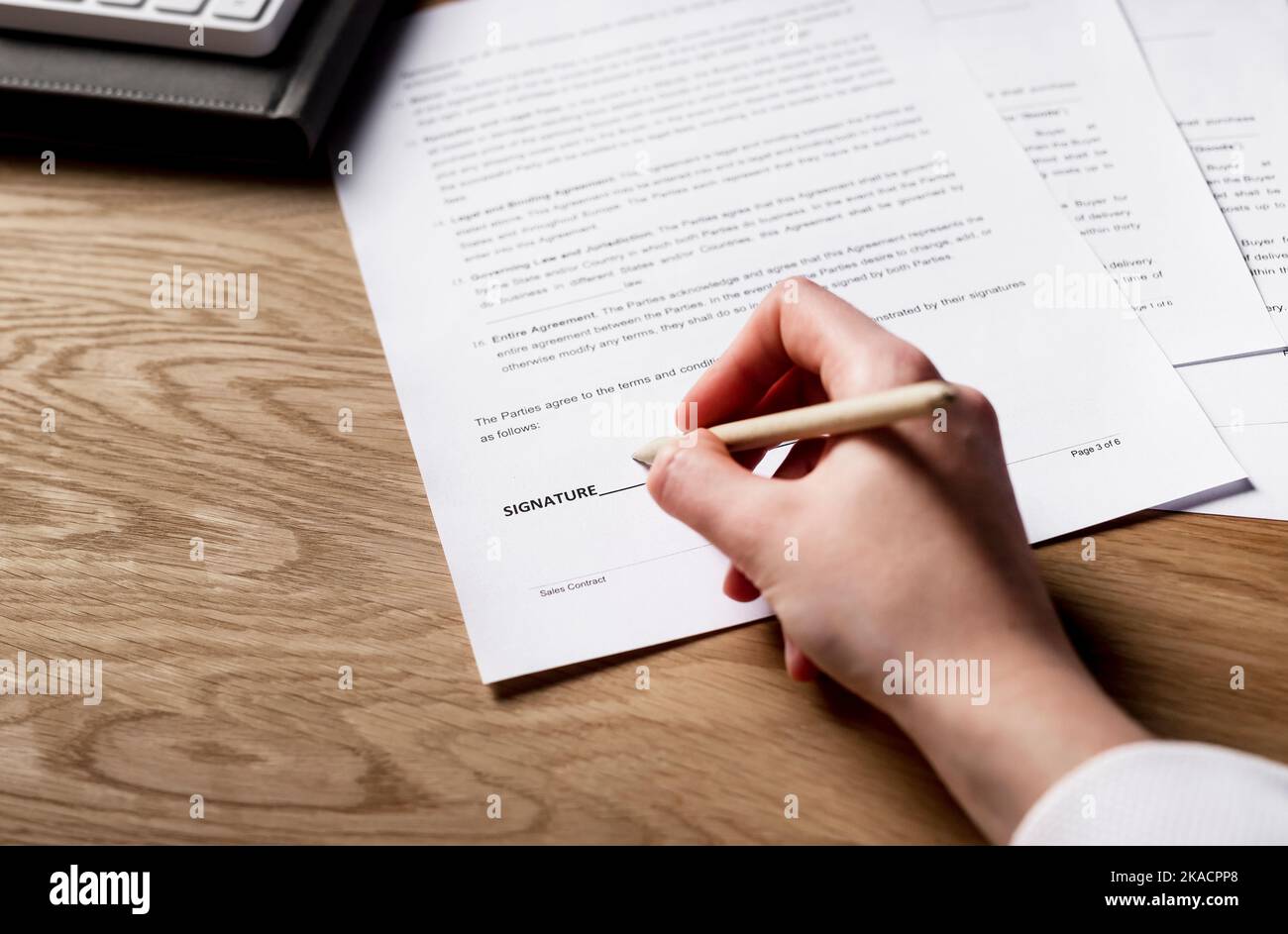 Signing business contract concept. Female hand putting her signature on ...