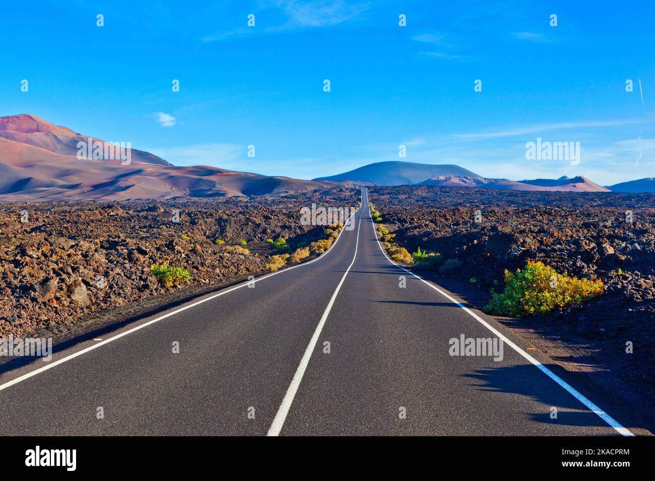Road between rocks in Timanfaya national Park Stock Photo - Alamy