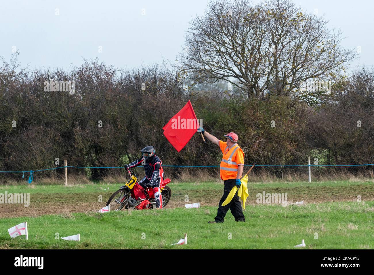 Red flag to stop racing in grasstrack motorcycle race. Donut Meeting ...