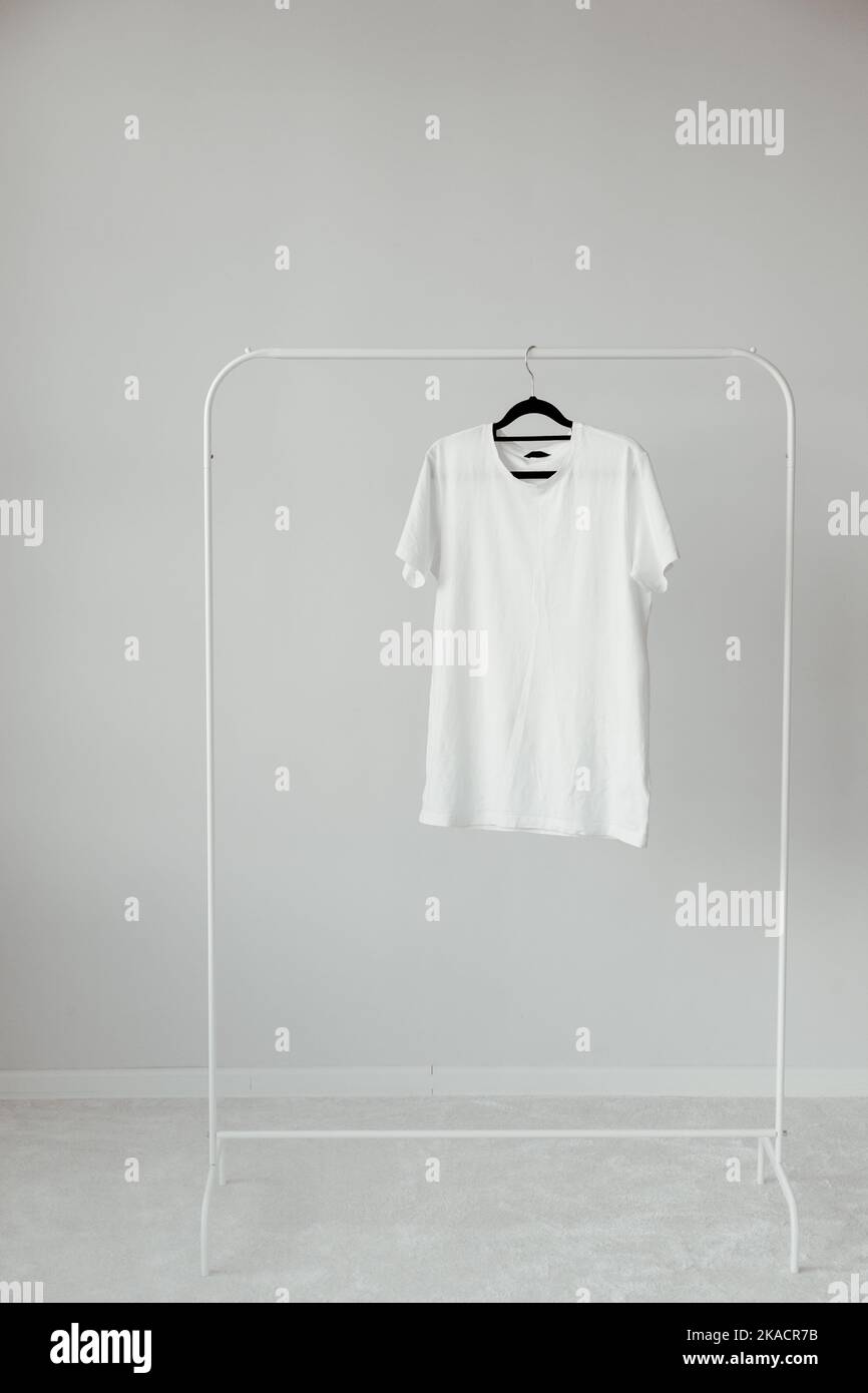 Blank White T-Shirt Mock-up hanging on white Rack Hanger, front view ...