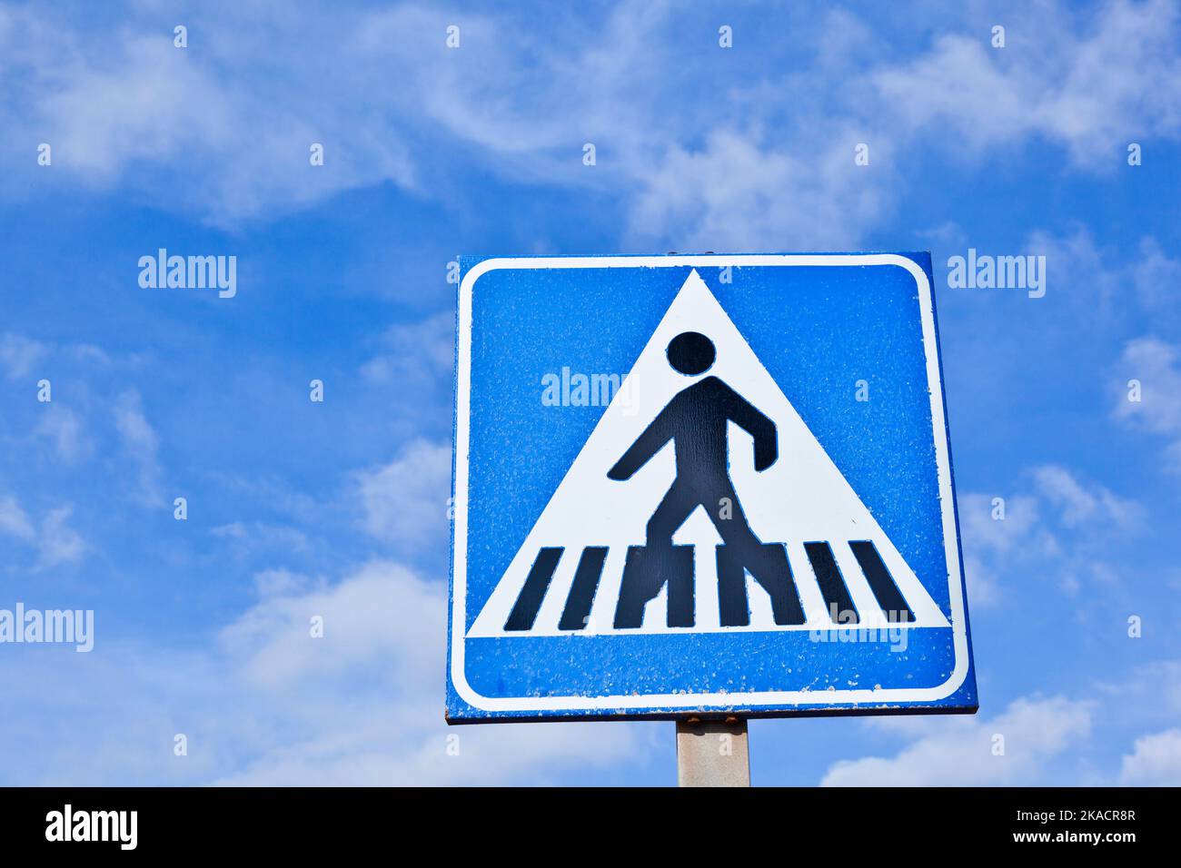 pedestrian crossing sign with blue sky Stock Photo - Alamy