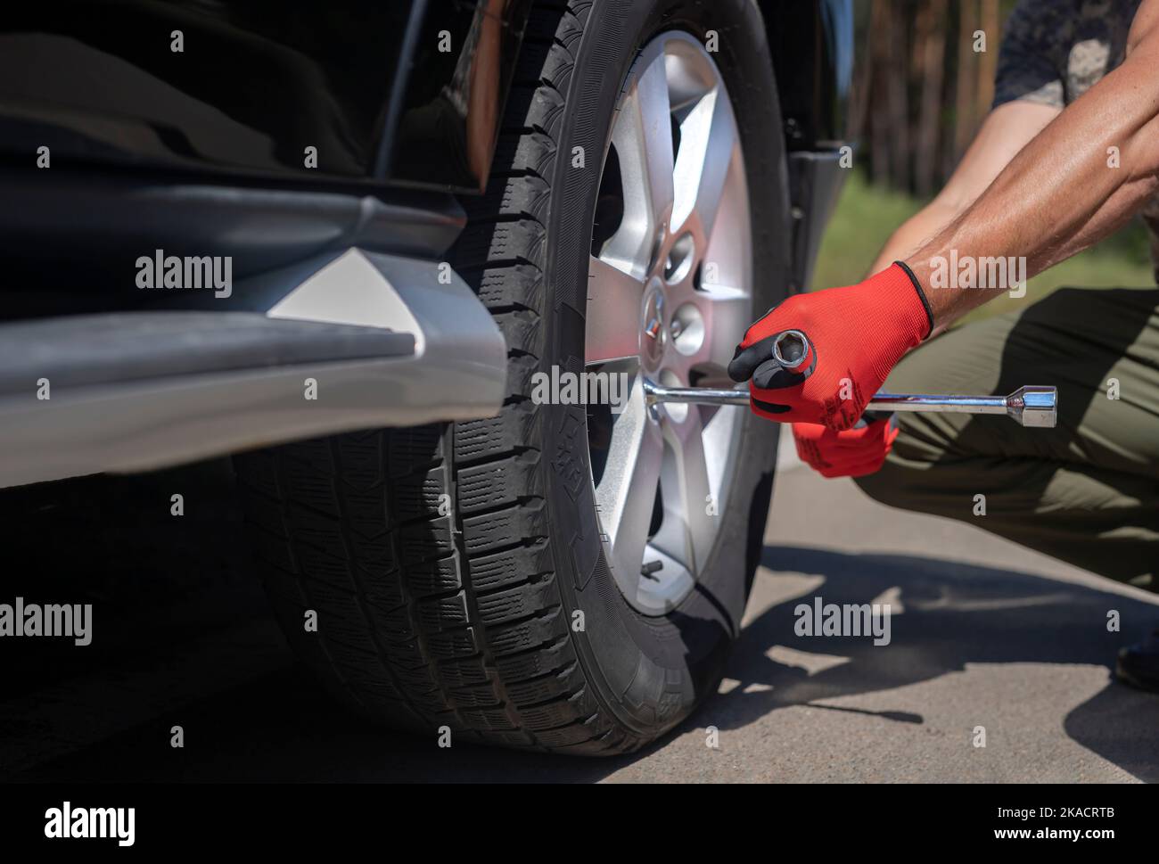 Fixing wheel tyre and disc of car with manual tool wrench Stock Photo ...