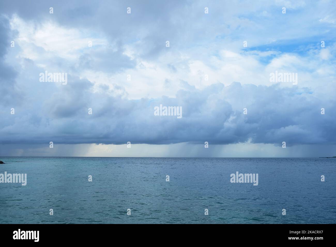 The monsoon season of Rasdhoo, with heavy gray cloud and rain, Maldives ...