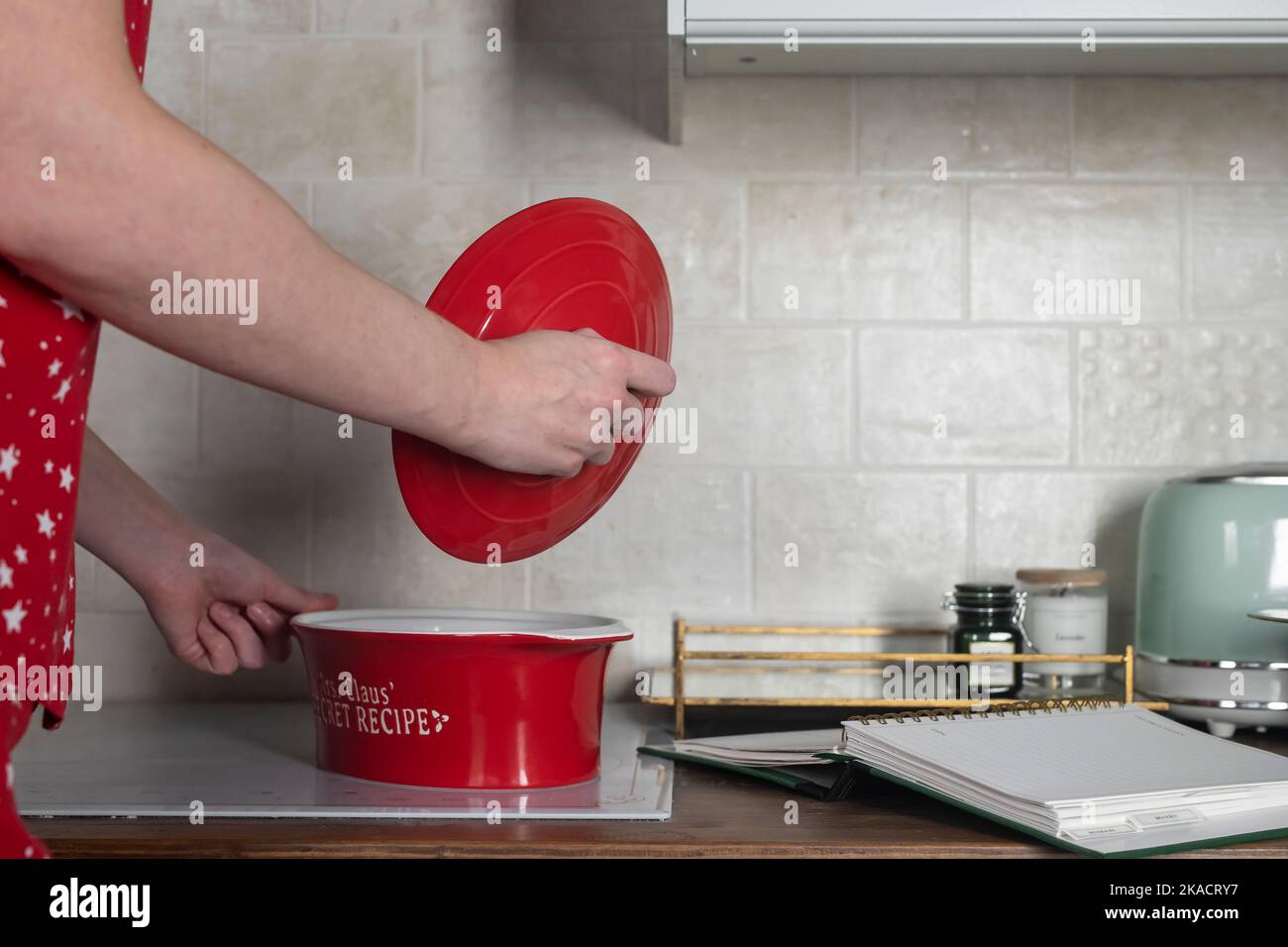 Cooking dinner in red pot at modern kitchen interior close up Stock ...