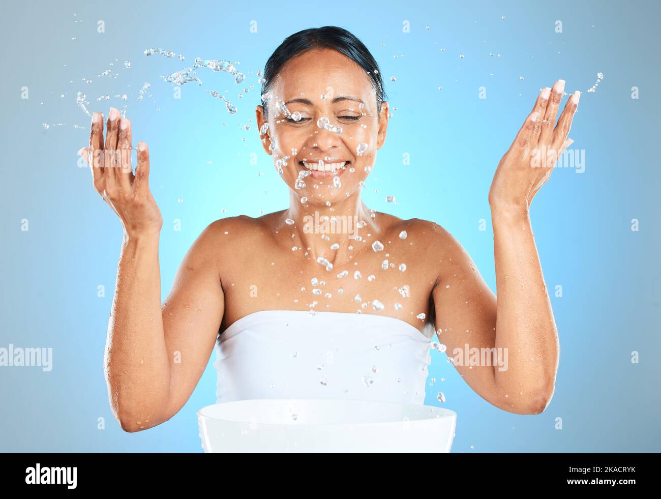 Water splash, skincare and beauty of a woman with a smile with healthy and skin wellness. Happy ...
