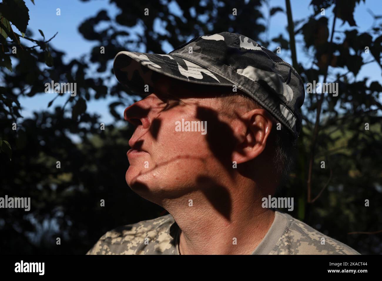 Portrait of calm man outside, immersed in nature, relaxing and ...