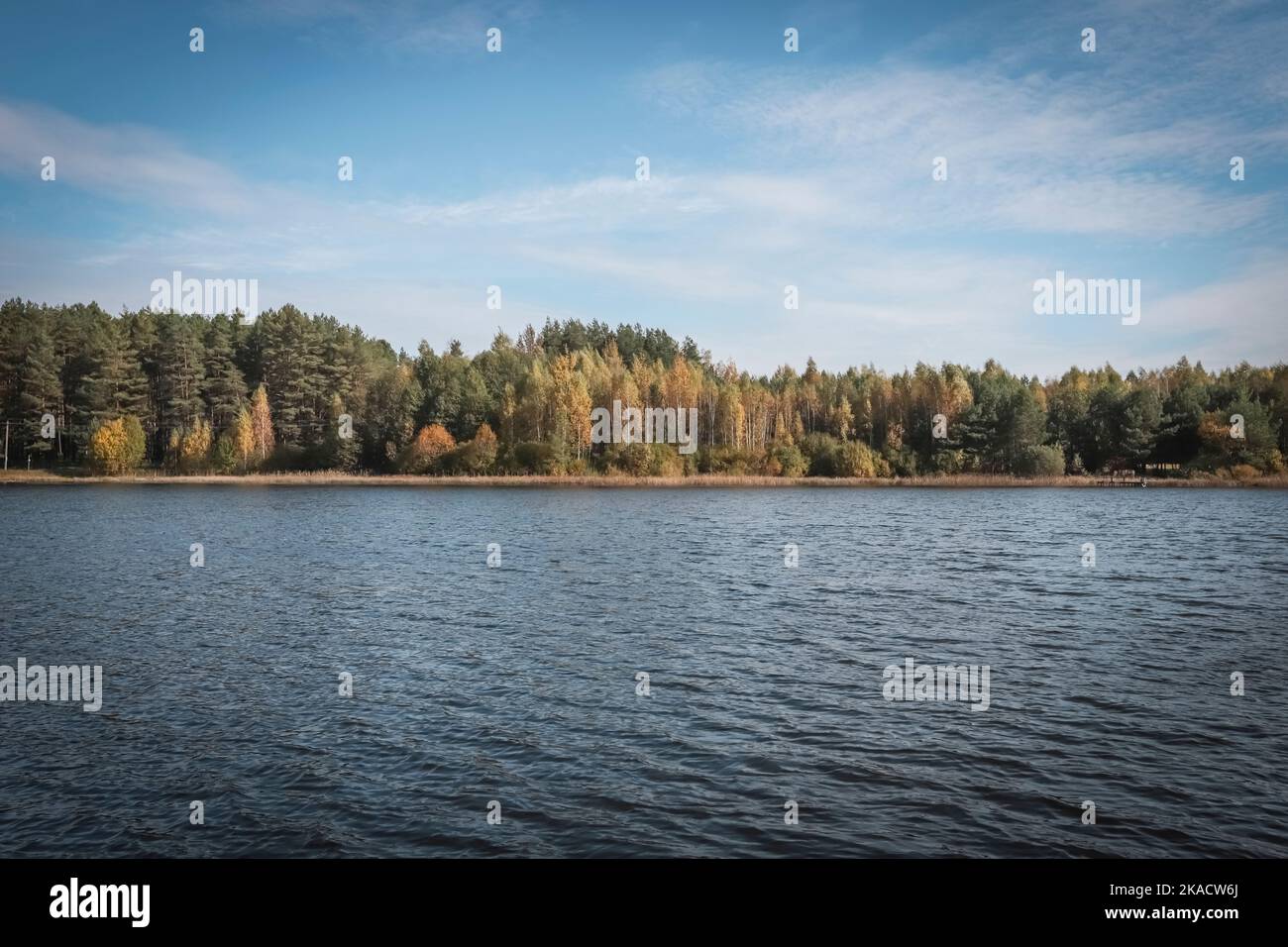 Fall serene landscape with green and yellow woods, its reflection in ...