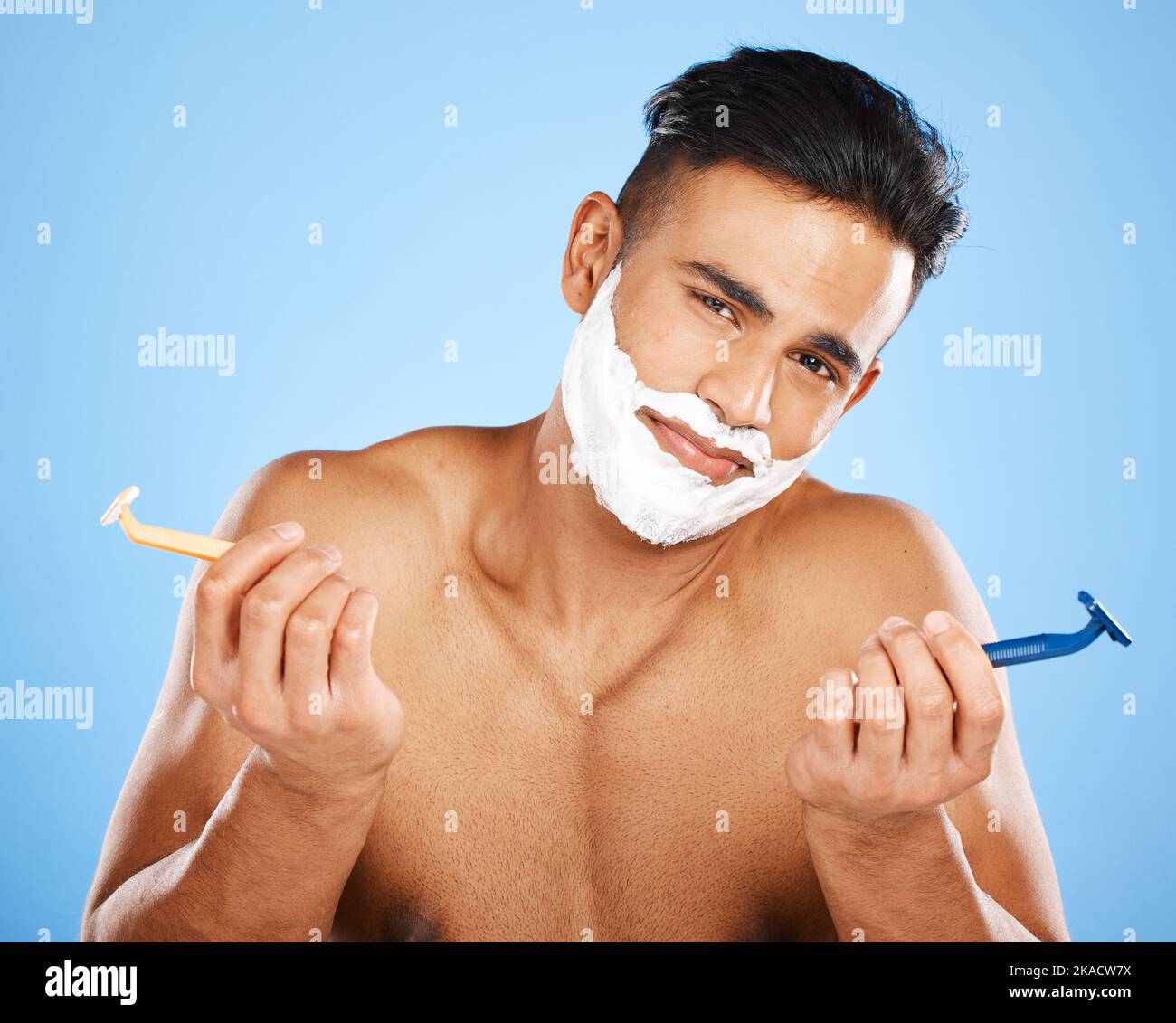 Razor, choice and portrait of man with shaving cream making decision to shave beard in studio ...