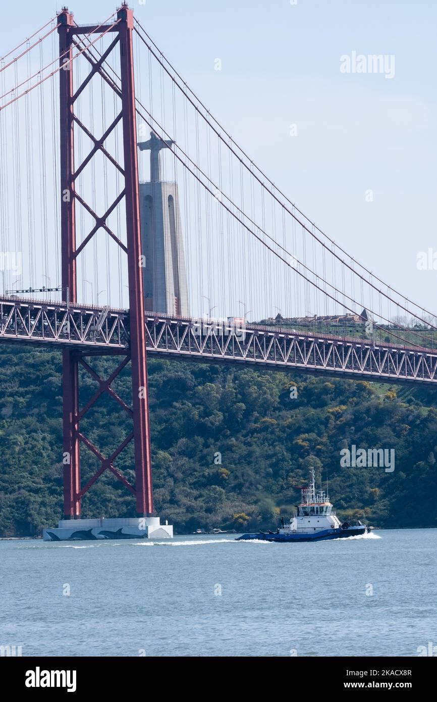 TUG, RIVER TAGUS: A tug under Ponte 25 de Abril bridge and Santuário de ...