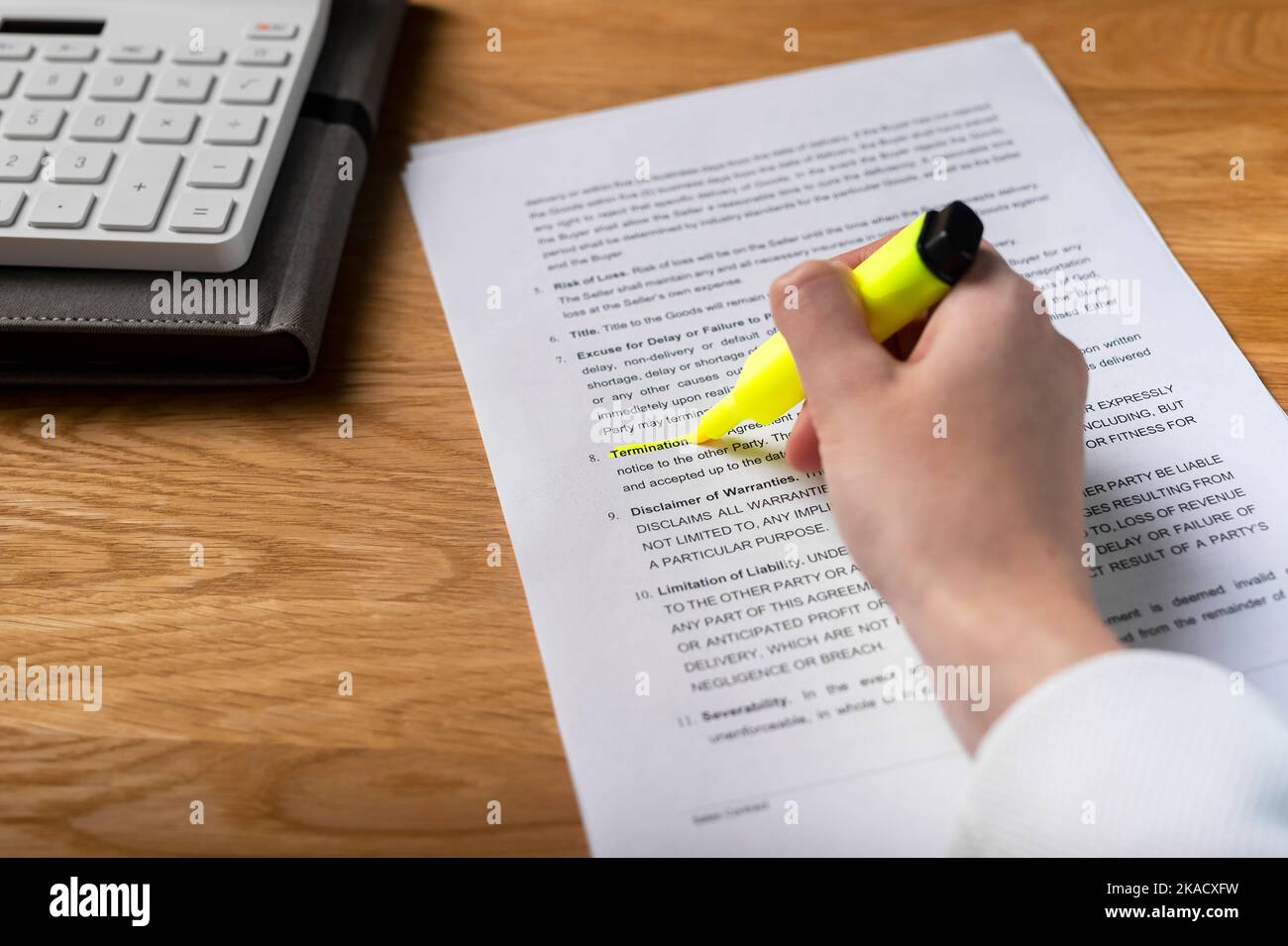 Contract terms of contract. Hand highlighting word in legal agreement ...