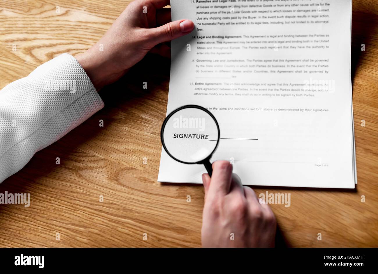Contract signing concept. Word signature through magnifying glass on ...