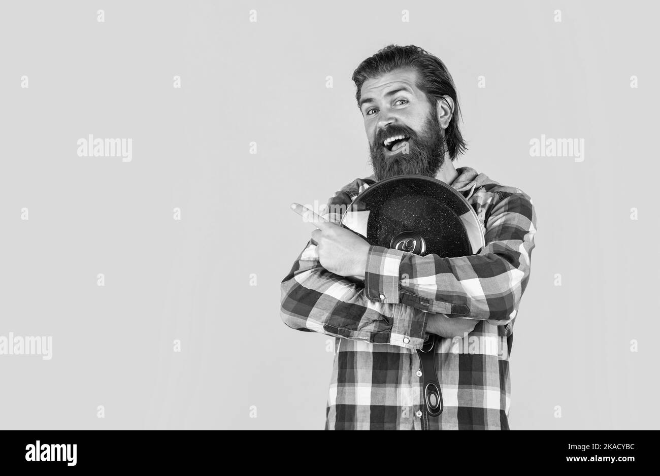stylish bearded guy with trendy hairstyle wear checkered shirt hold pan ...