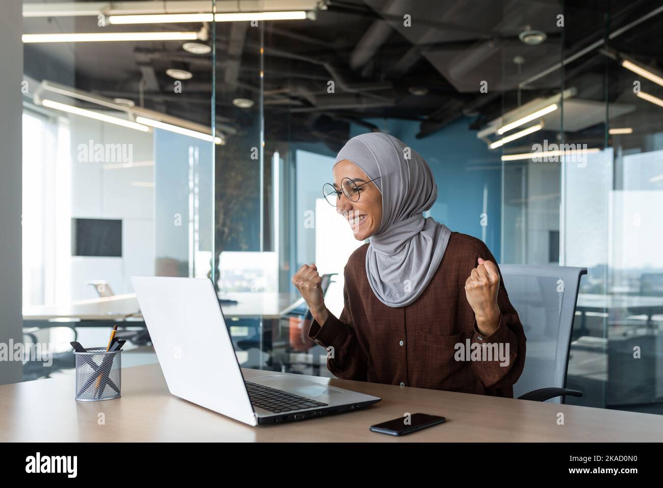 Successful businesswoman boss celebrating victory and successful ...