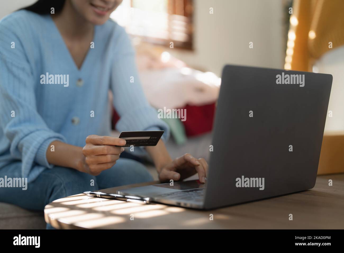 Young person using credit card and laptop computer. Online shopping, e ...