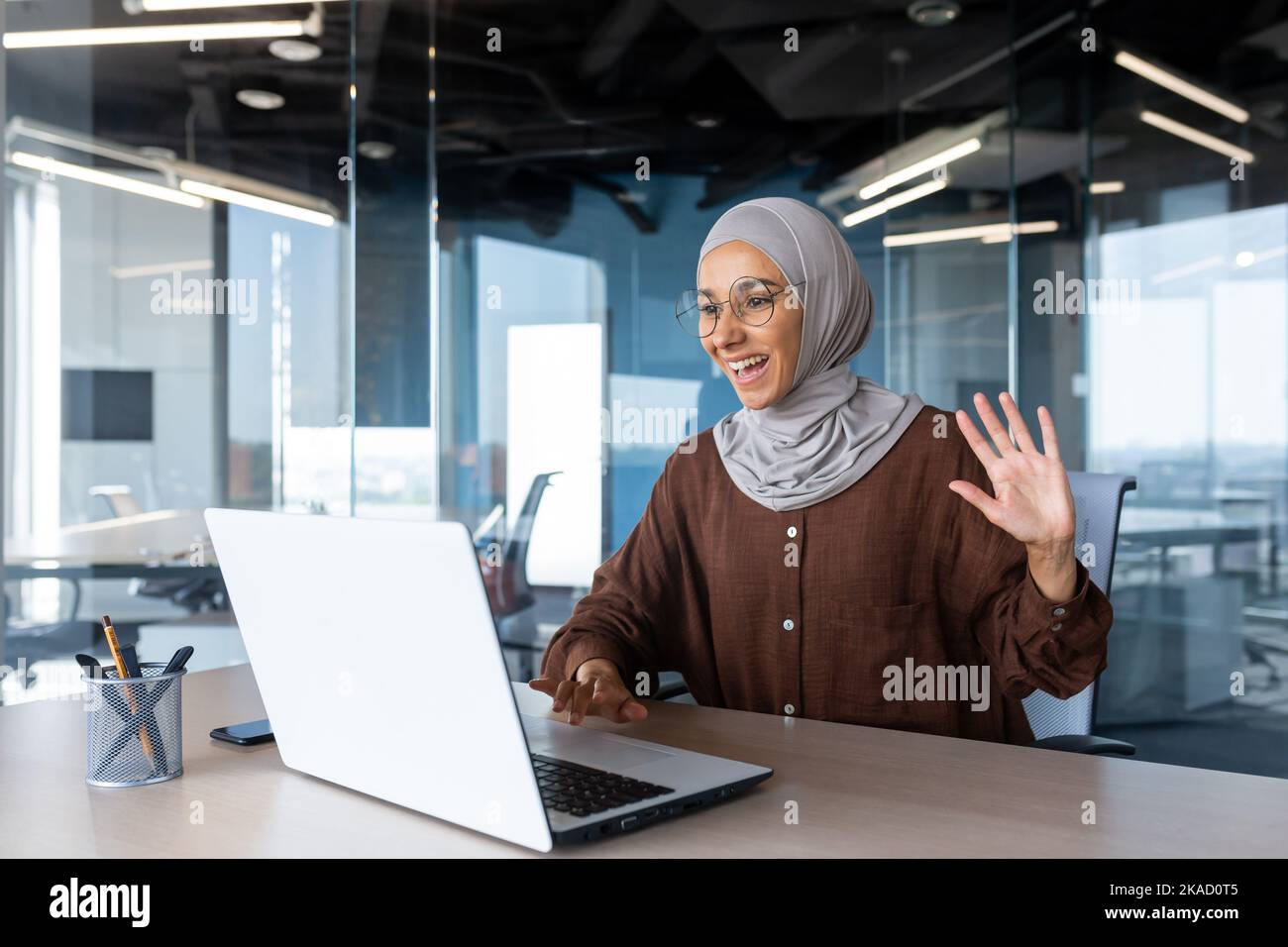 Businesswoman in hijab works inside a modern office building, Muslim ...