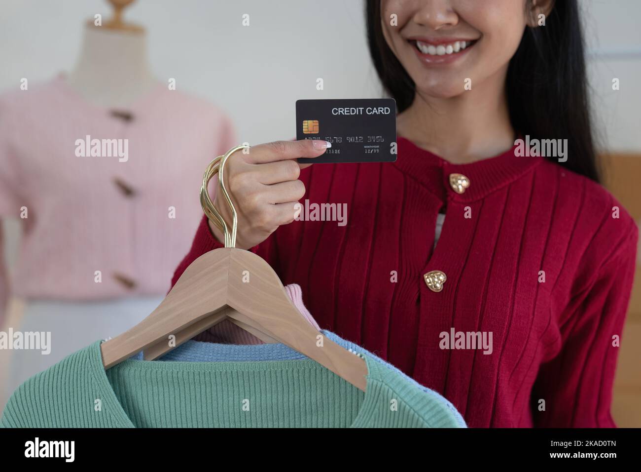 Young person using credit card and laptop computer. Online shopping, e ...