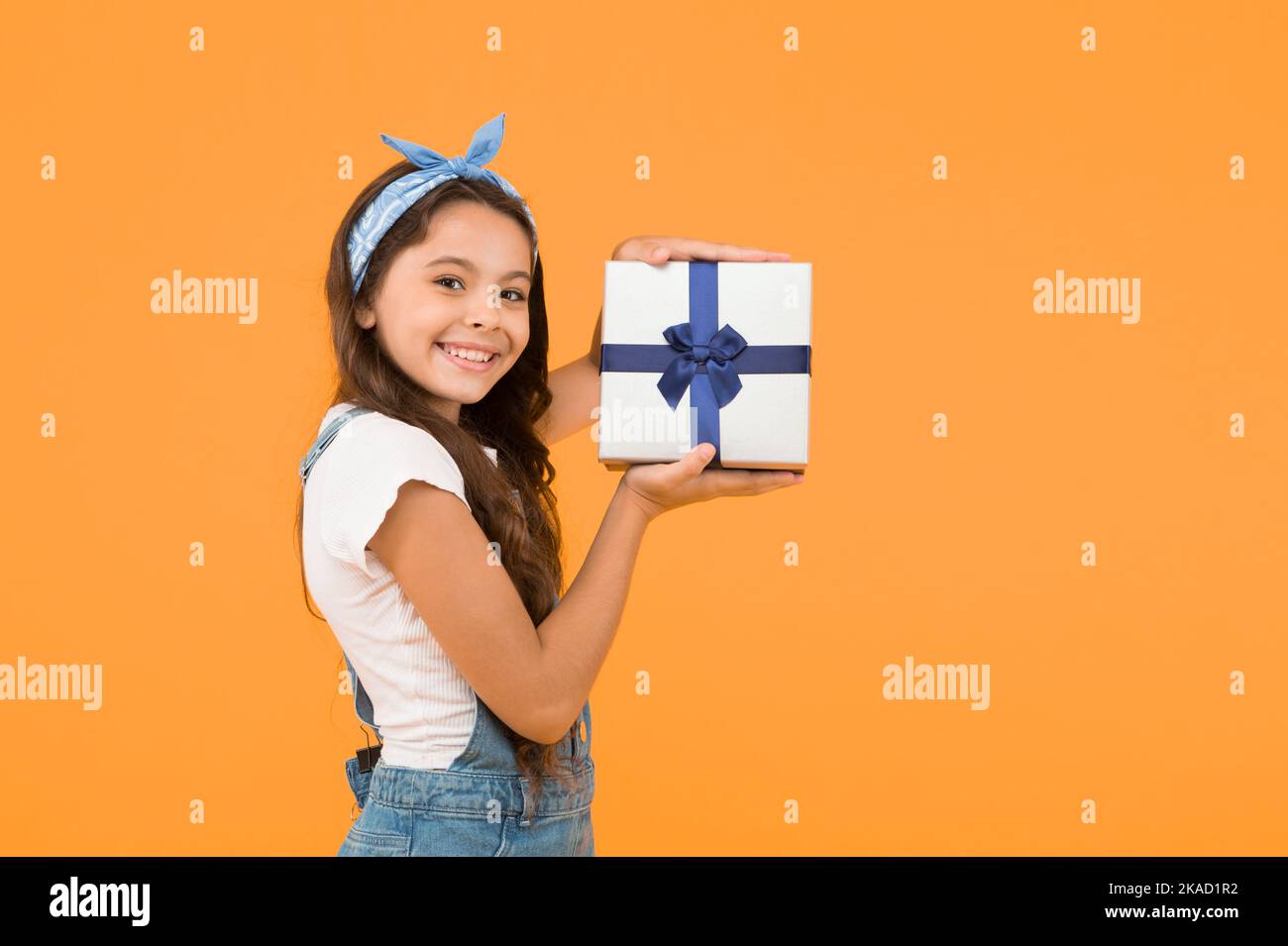 Child smiling happy hold gift box. Kid girl delighted gift. Unexpected ...