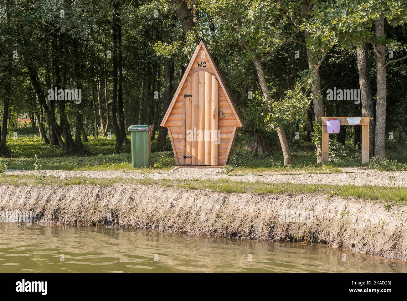 Wood WC in nature in summer. Outhouse latrine with WC inscription Stock ...