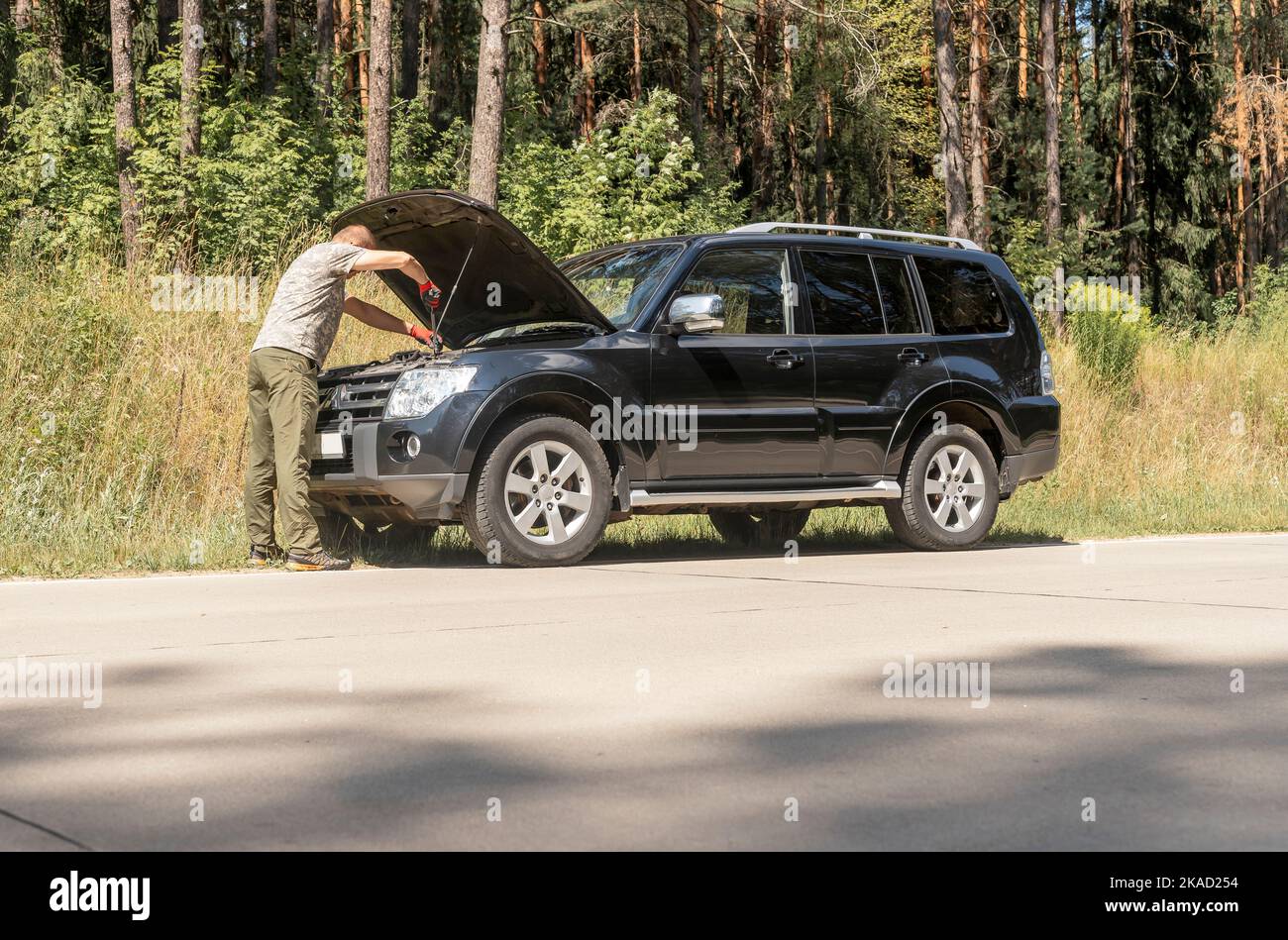 MINSK, BELARUS - October 17 2021 Driver standing and looking inside ...