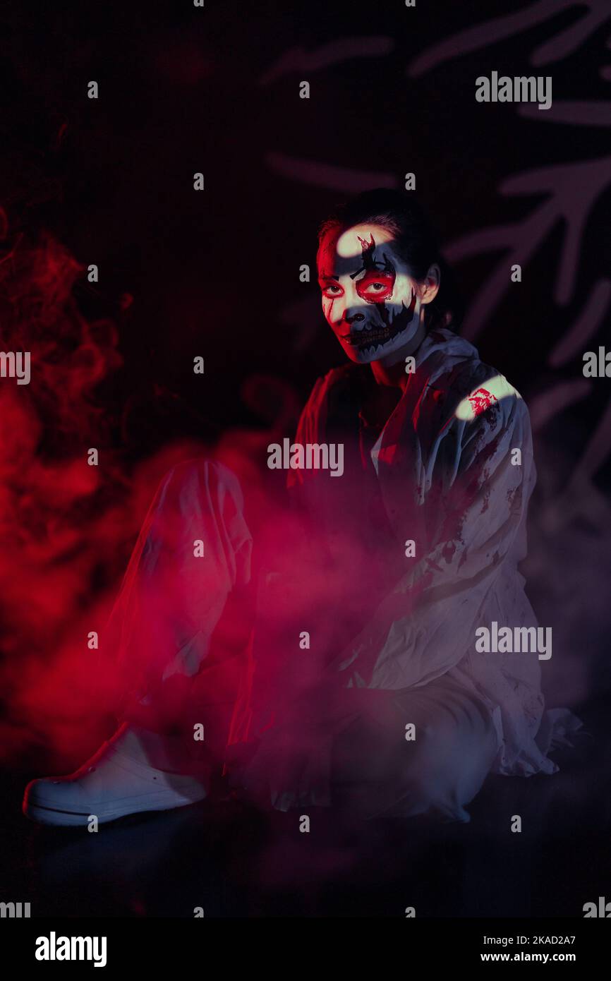 Litted woman portrays bloodthirsty zombie with horror wounds on her ...