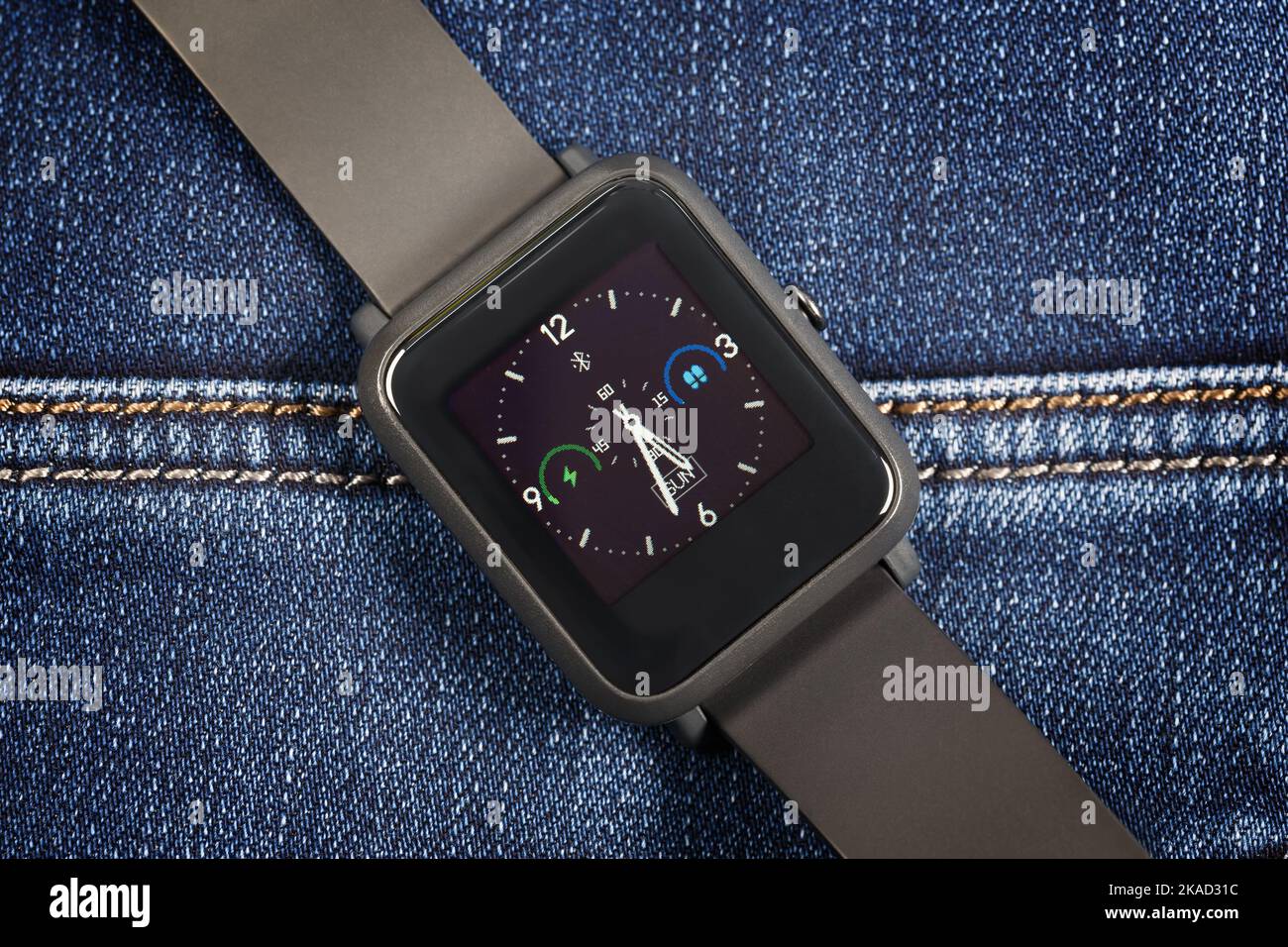 A smart watch with a gray strap lies on jeans. Close-up Stock Photo - Alamy
