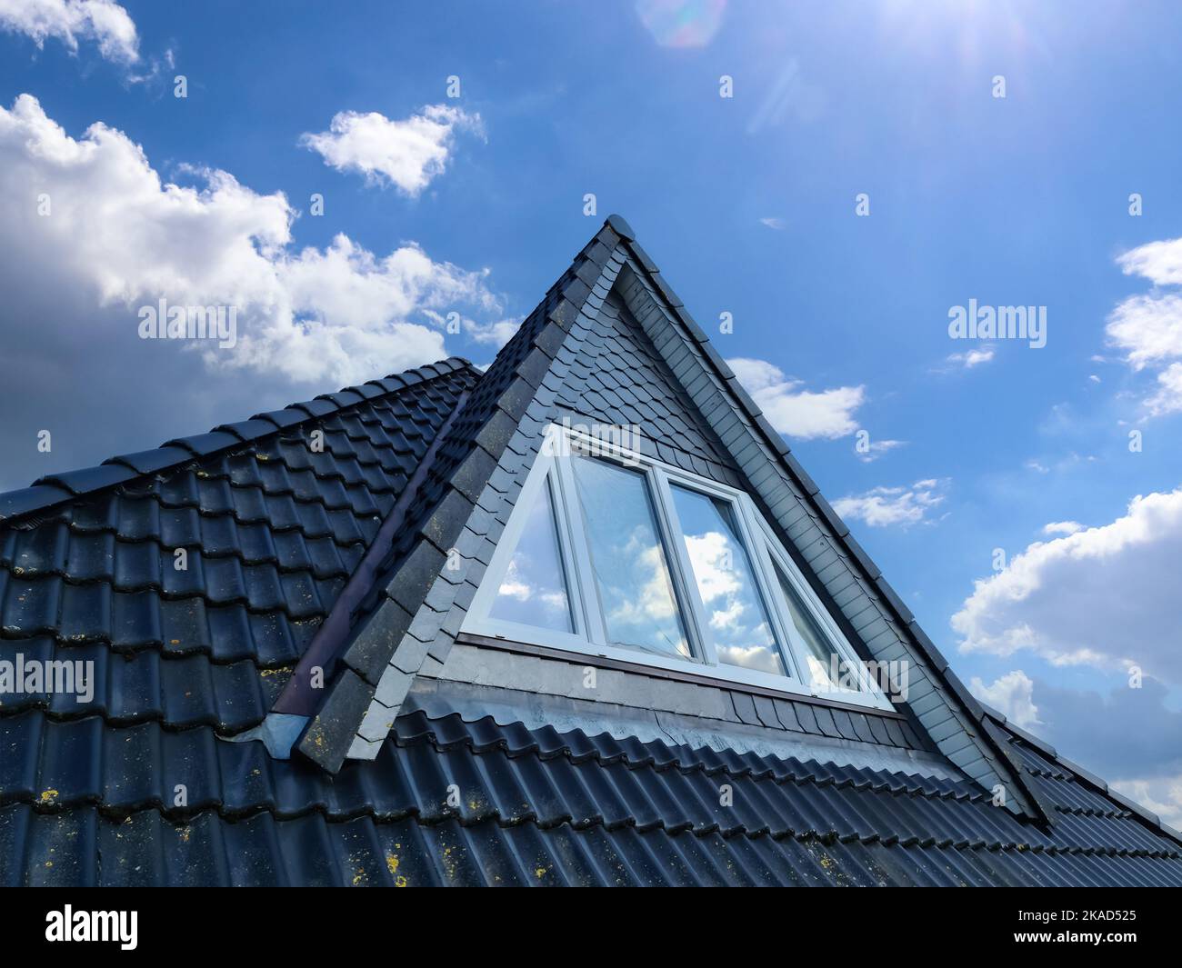 Roof window in velux style with black roof tiles Stock Photo - Alamy