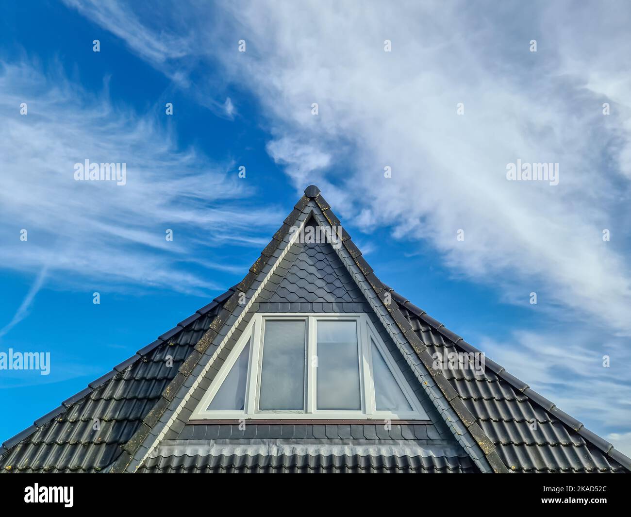 Roof window in velux style with black roof tiles Stock Photo - Alamy