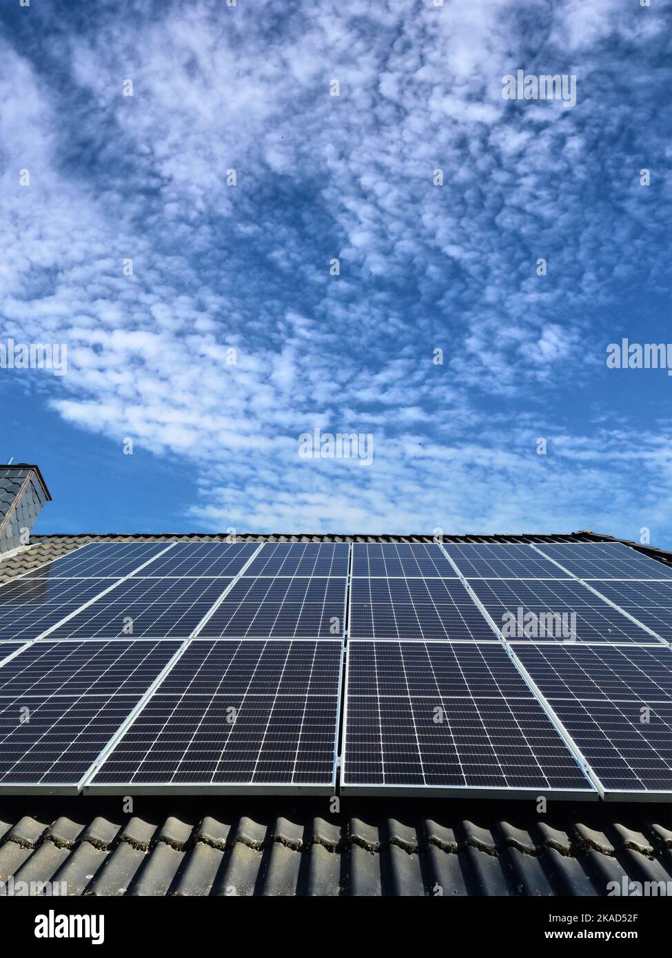 Solar panels producing clean energy on a roof of a residential house ...