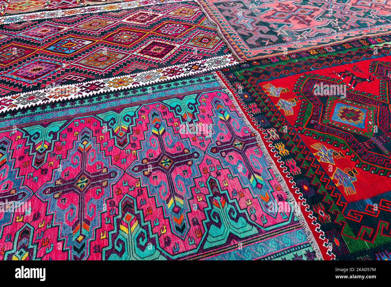 A street market with many colorful carpets lying on a cobbled street in ...
